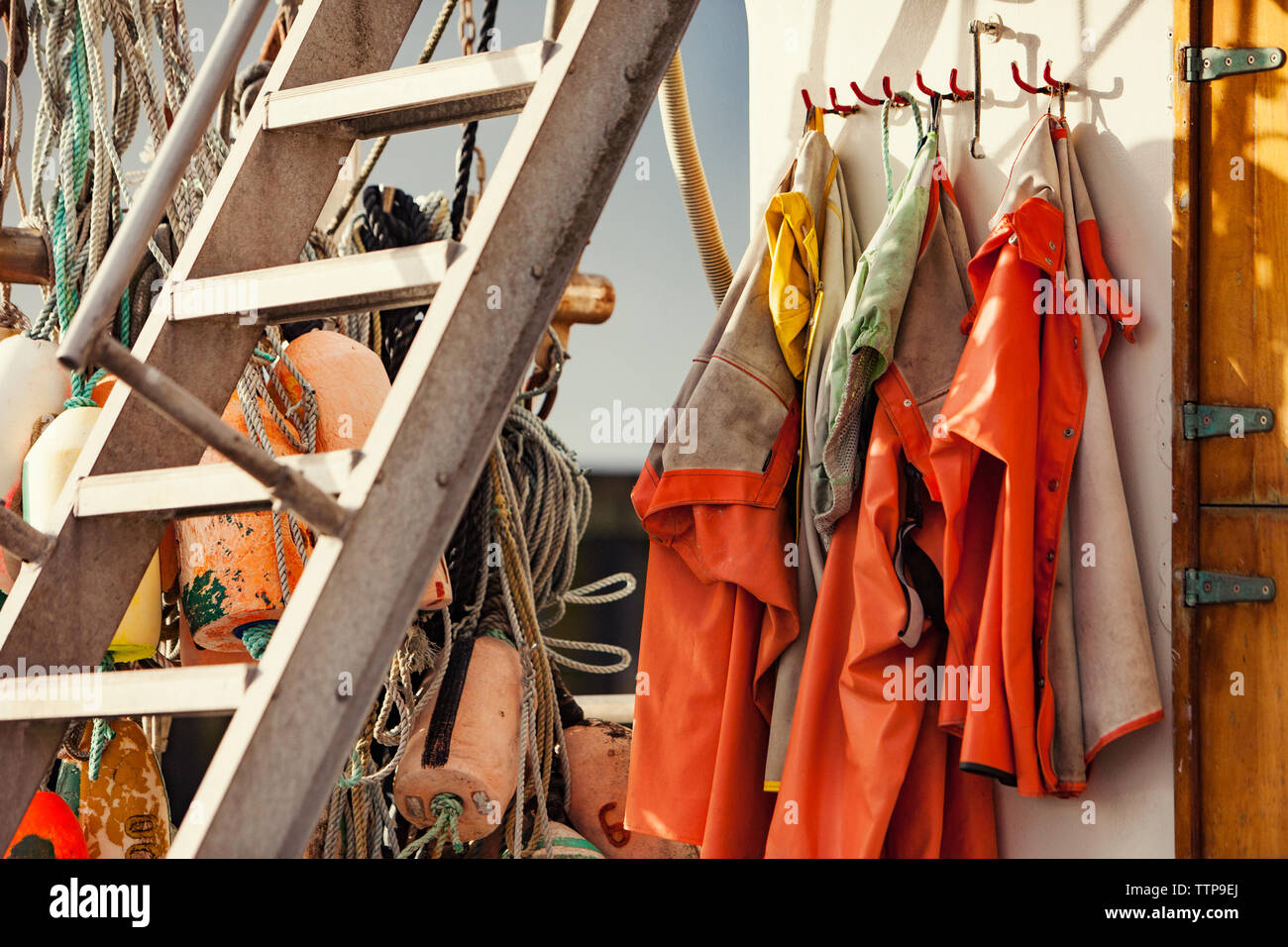 Clothes hanging by ladder and buoys Stock Photo - Alamy
