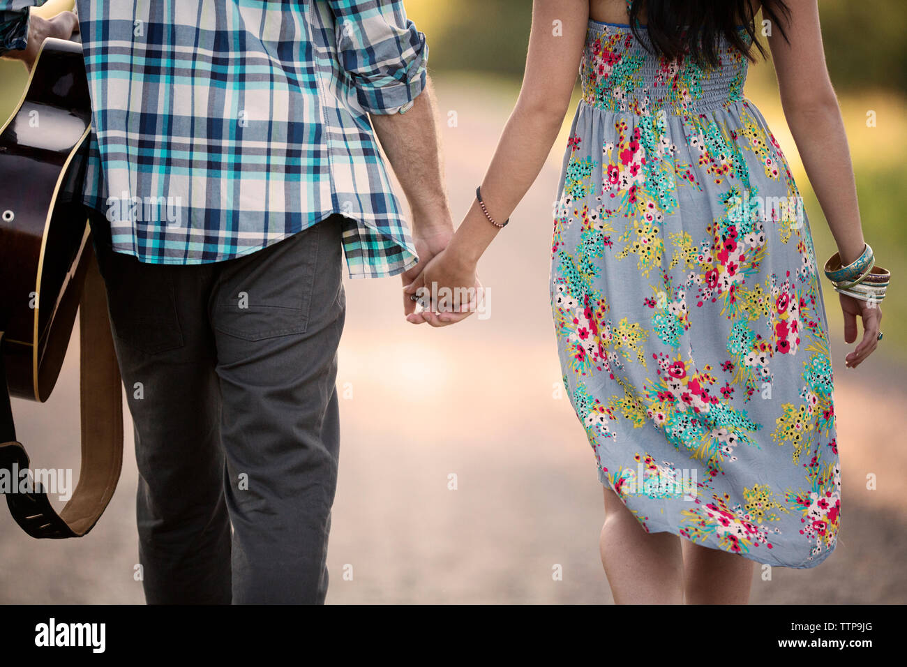 Couple Walking Hand In Hand On Road