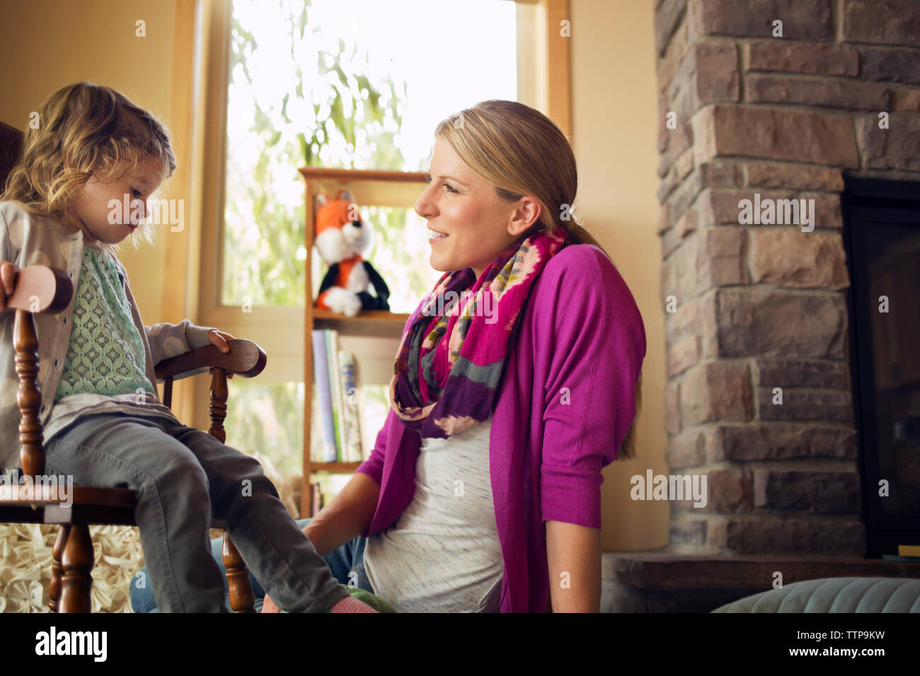 Mother talking to daughter while relaxing at home Stock Photo - Alamy
