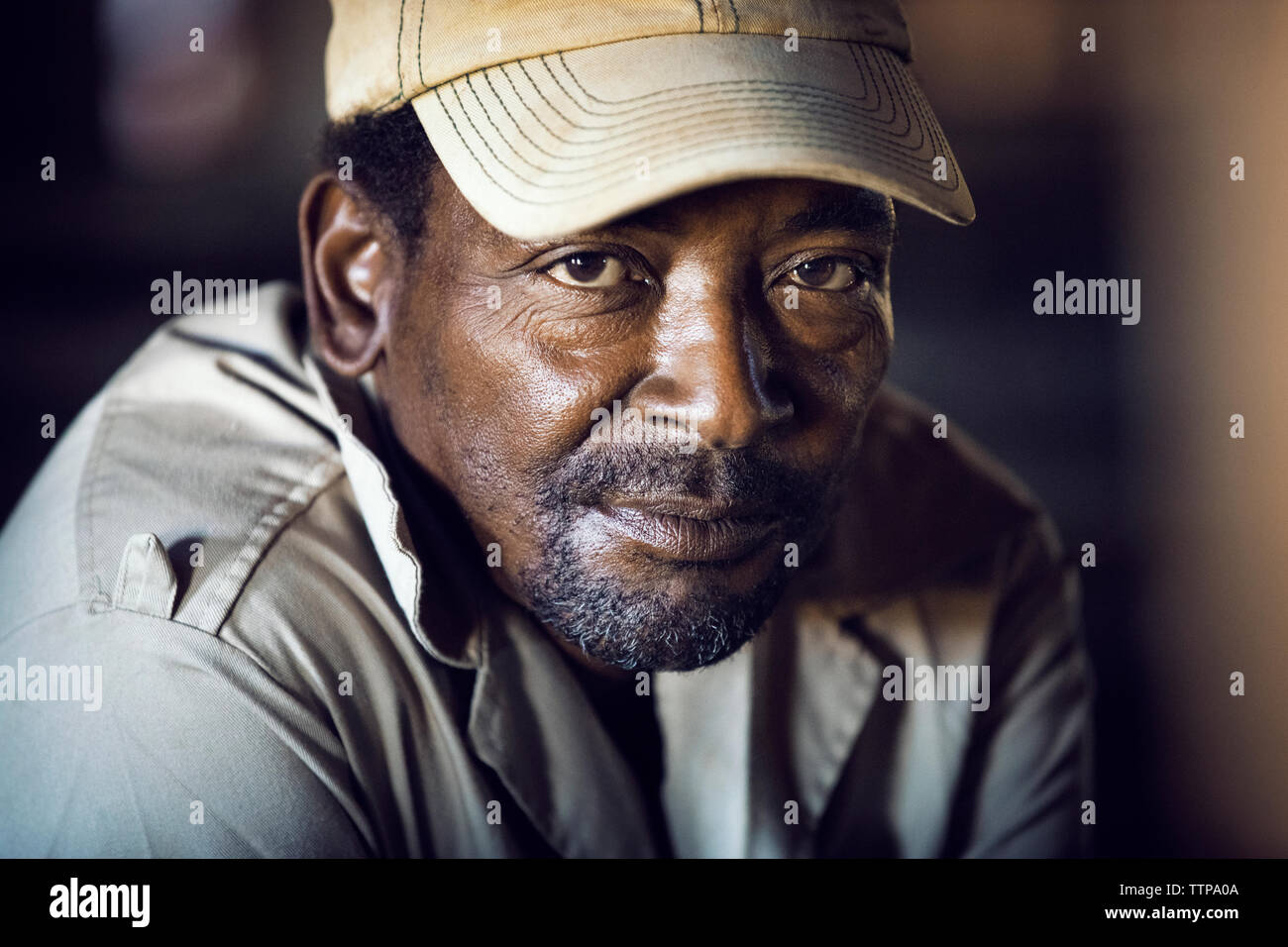 Portrait of serious looking man with cap hi-res stock photography and ...