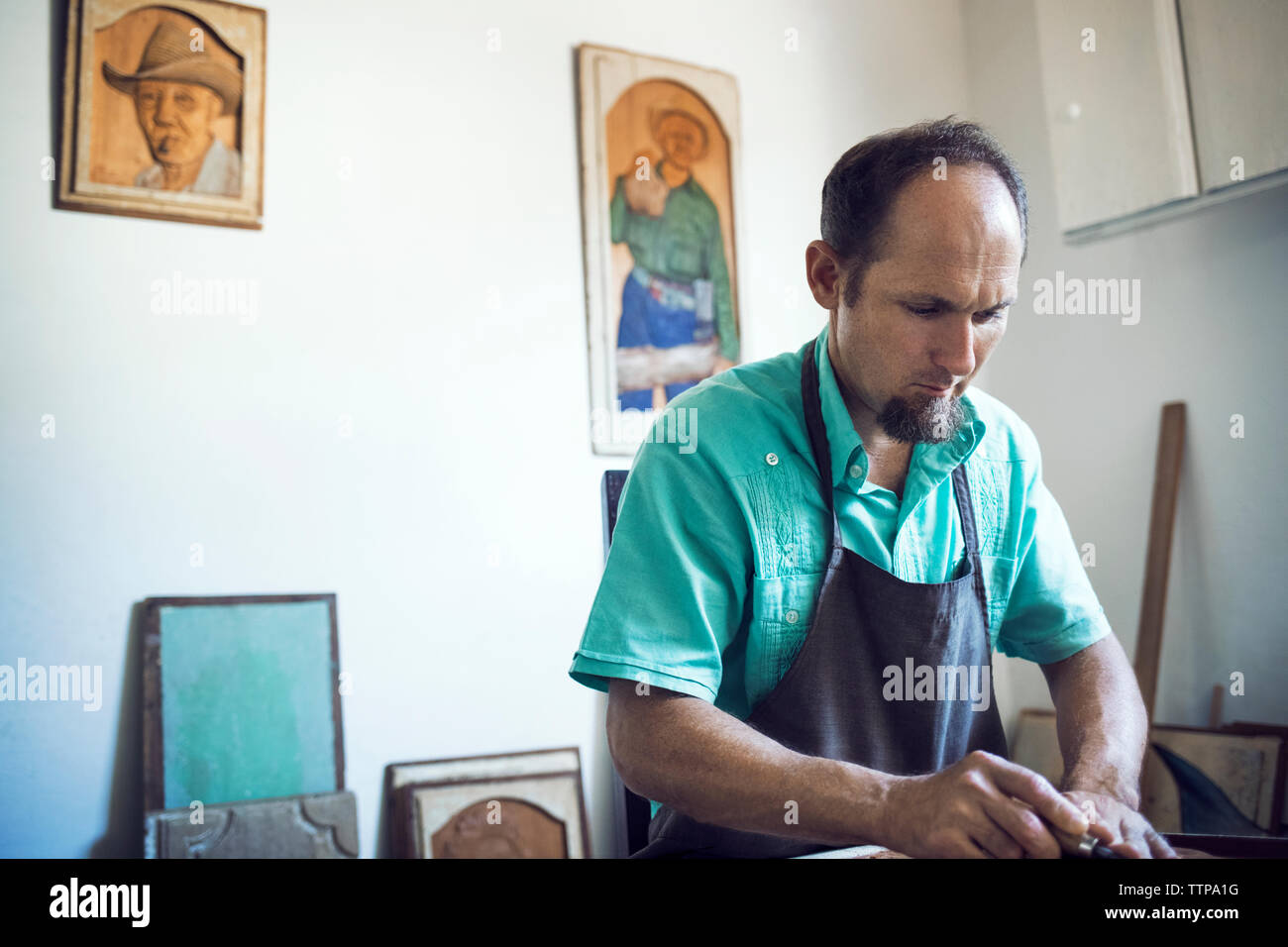 Craftsperson carving in workshop Stock Photo - Alamy