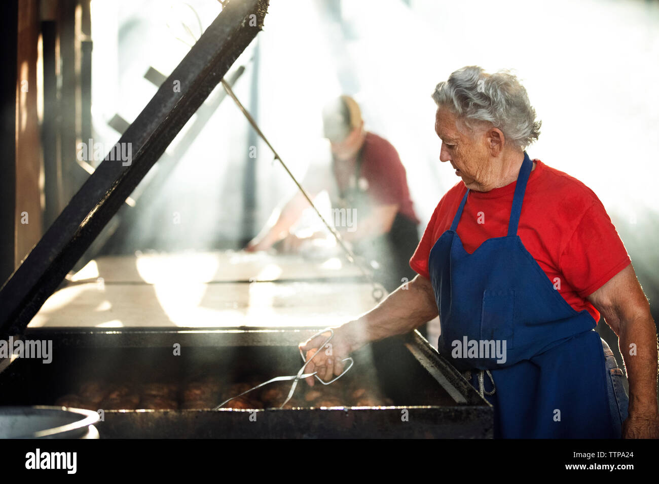 Workers cooking food in kitchen Stock Photo - Alamy