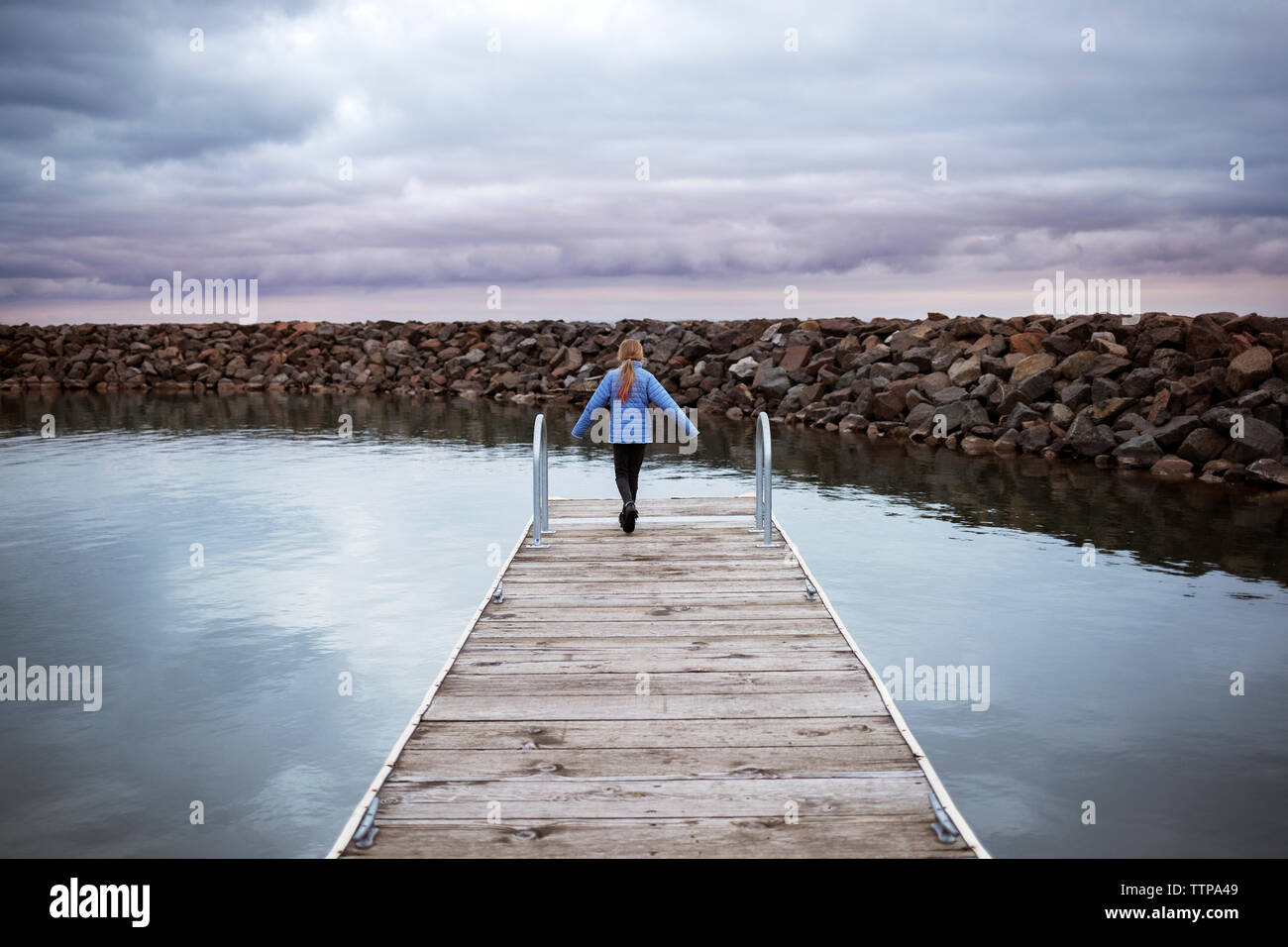 Girl walking over rocks hi-res stock photography and images - Alamy