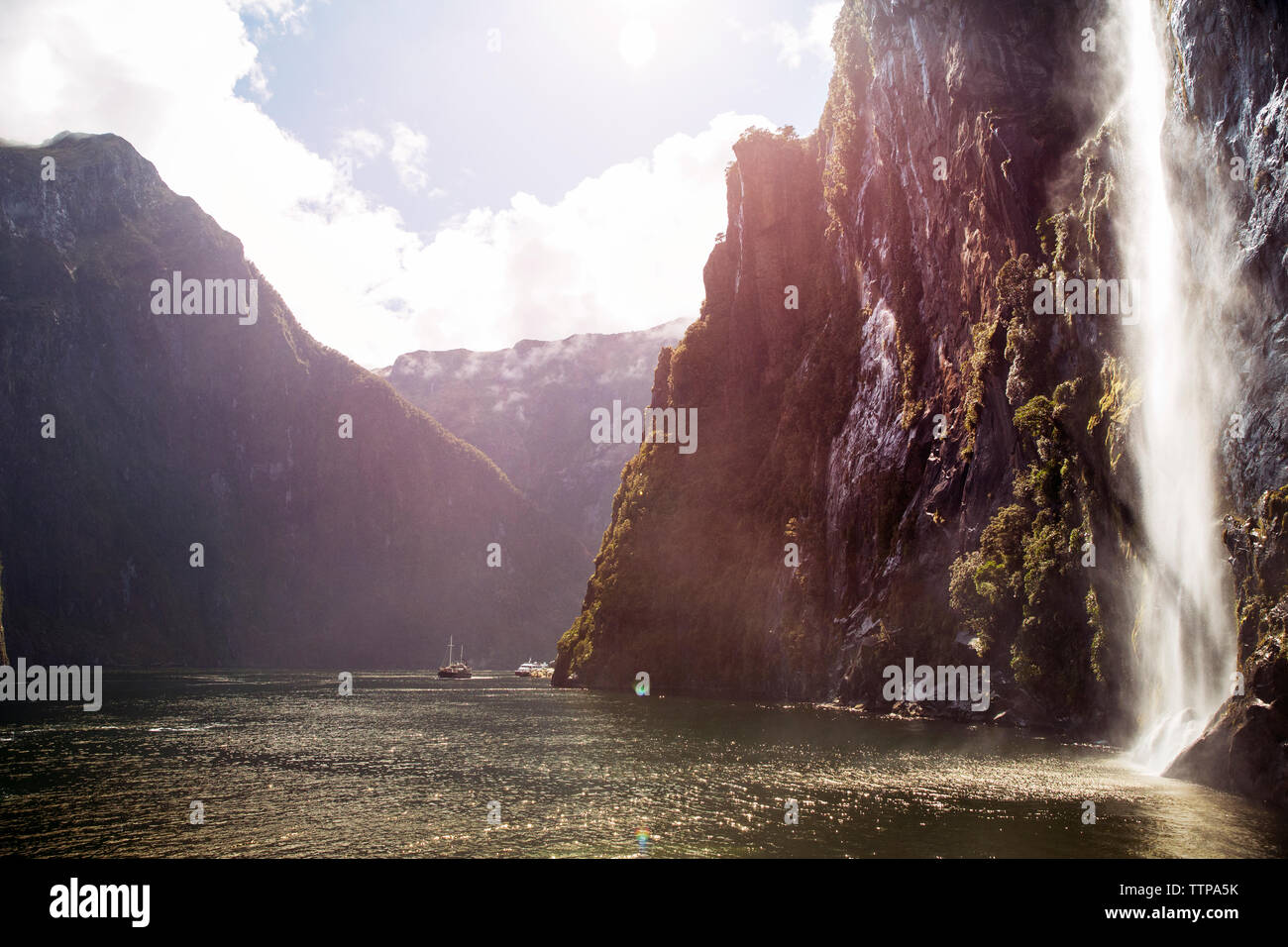 Scenic view of waterfall over mountain by river Stock Photo - Alamy