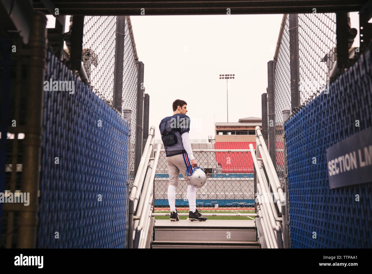 Low angle view of American football player standing at stadium seen ...