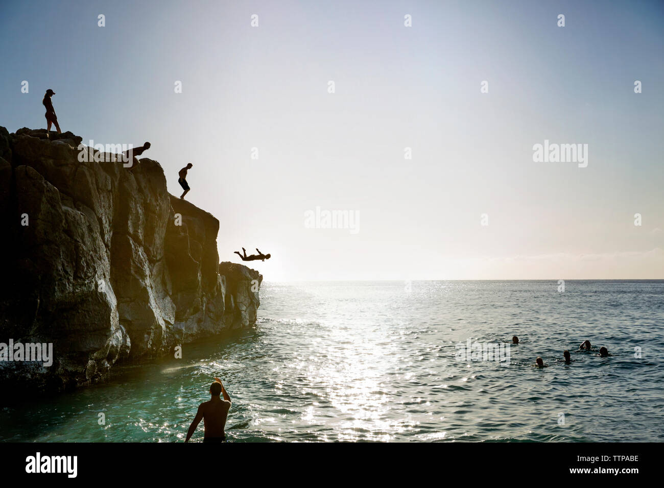 Silhouette friends jumping over hi-res stock photography and images - Alamy