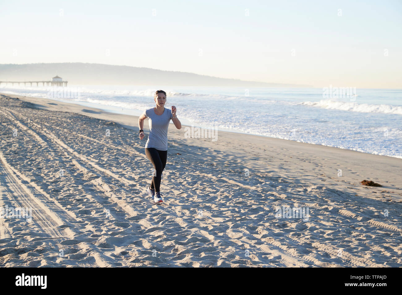 Woman jogging beach hi-res stock photography and images - Alamy
