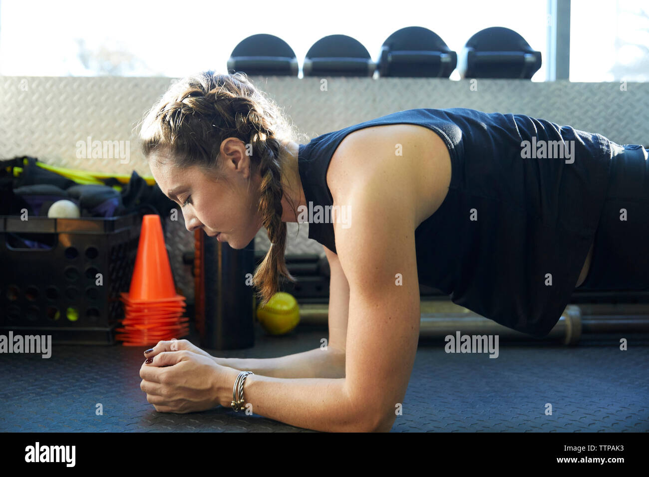 Side view of woman exercising at gym Stock Photo - Alamy