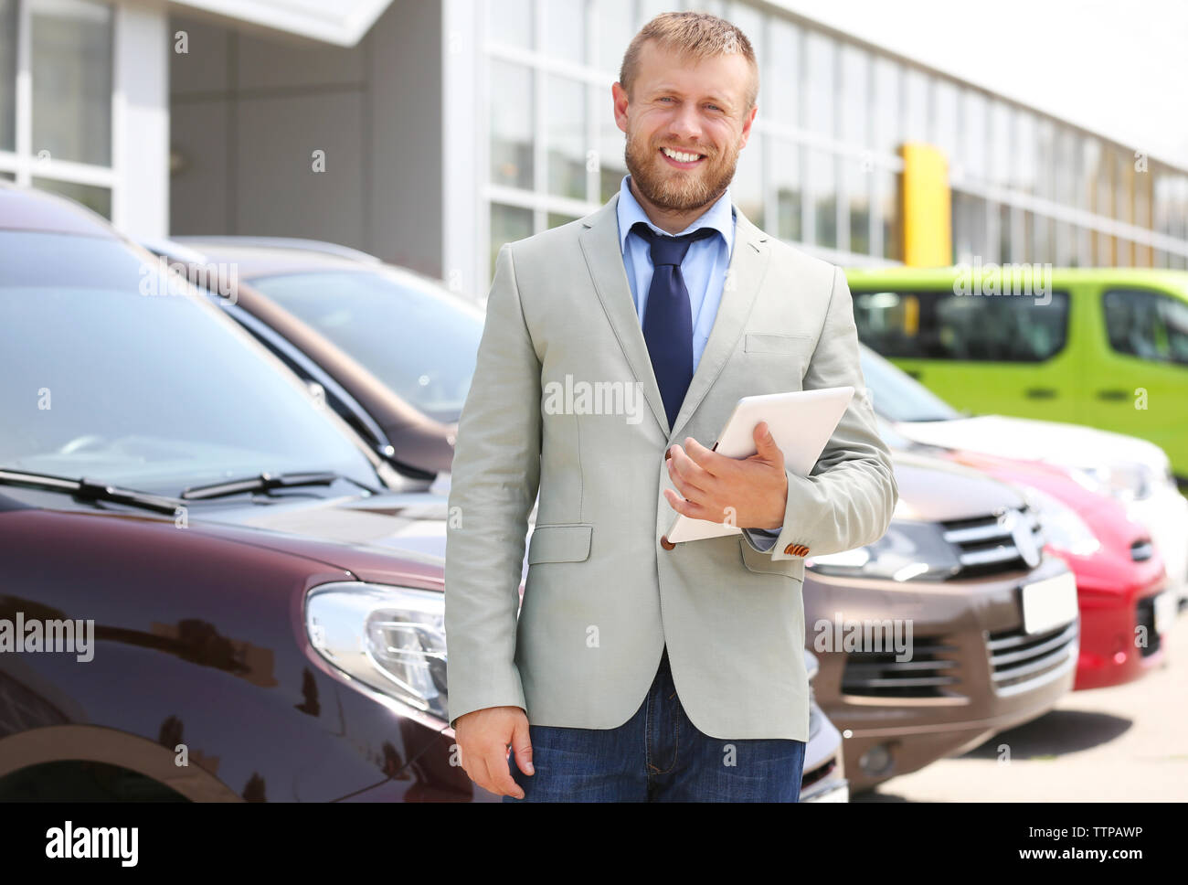 Car dealer on new cars background Stock Photo - Alamy