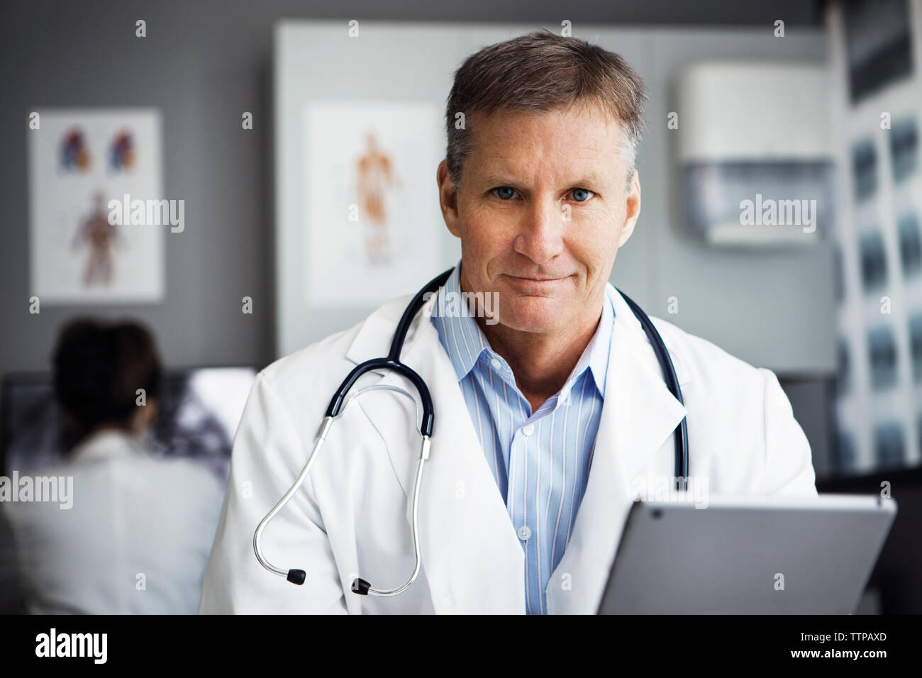 Doctor with computer looking at camera hi-res stock photography and ...