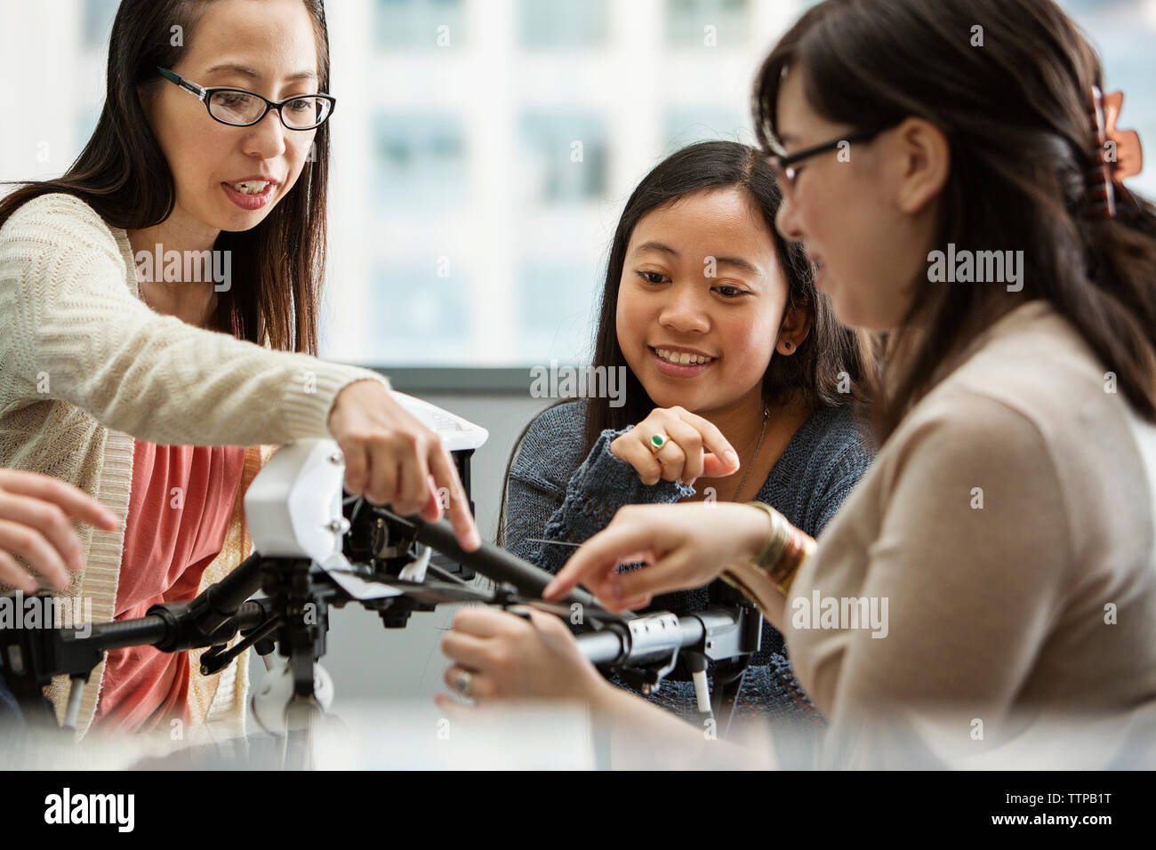 Teacher explaining drone to students in classroom Stock Photo - Alamy