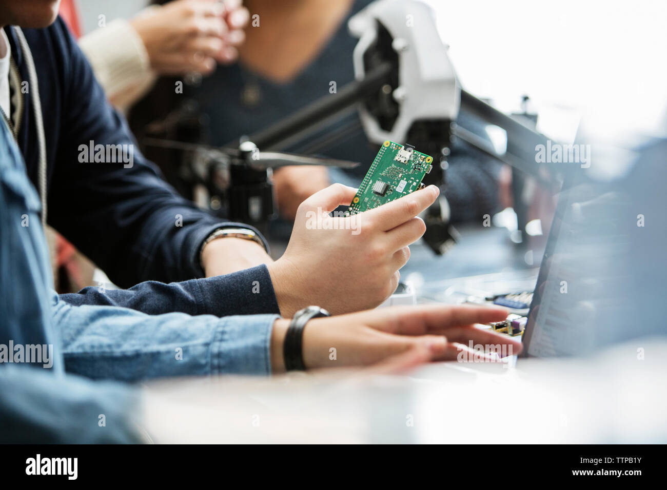 Cropped image of students holding circuit board in classroom Stock ...
