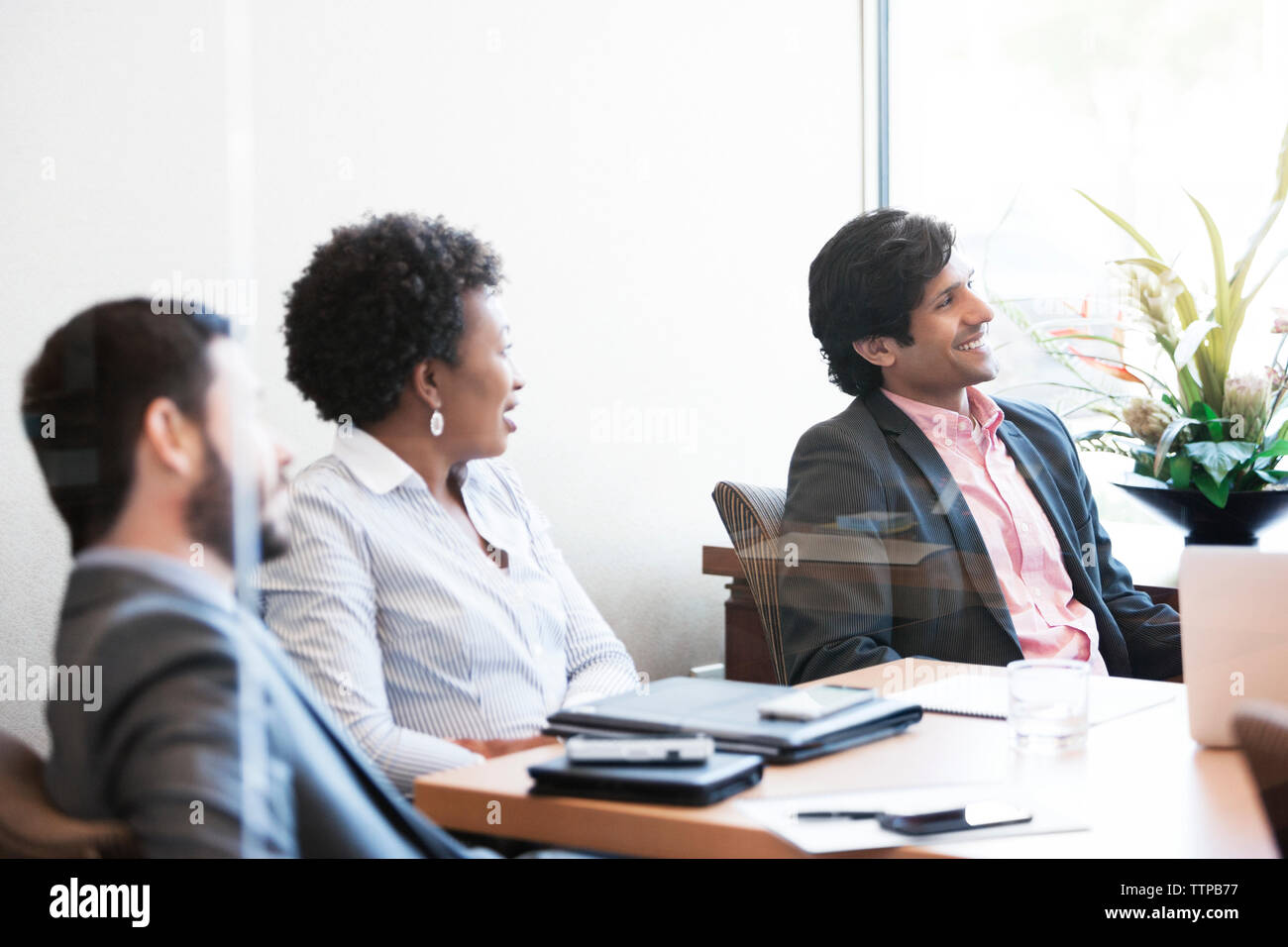 business people sitting at desk in conference room Stock Photo - Alamy