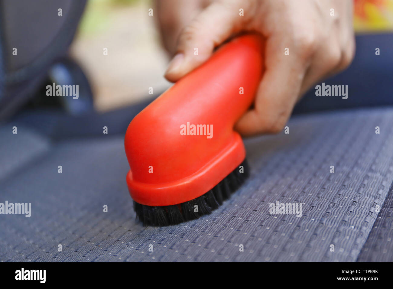 Male hand cleaning car with brush inside Stock Photo - Alamy