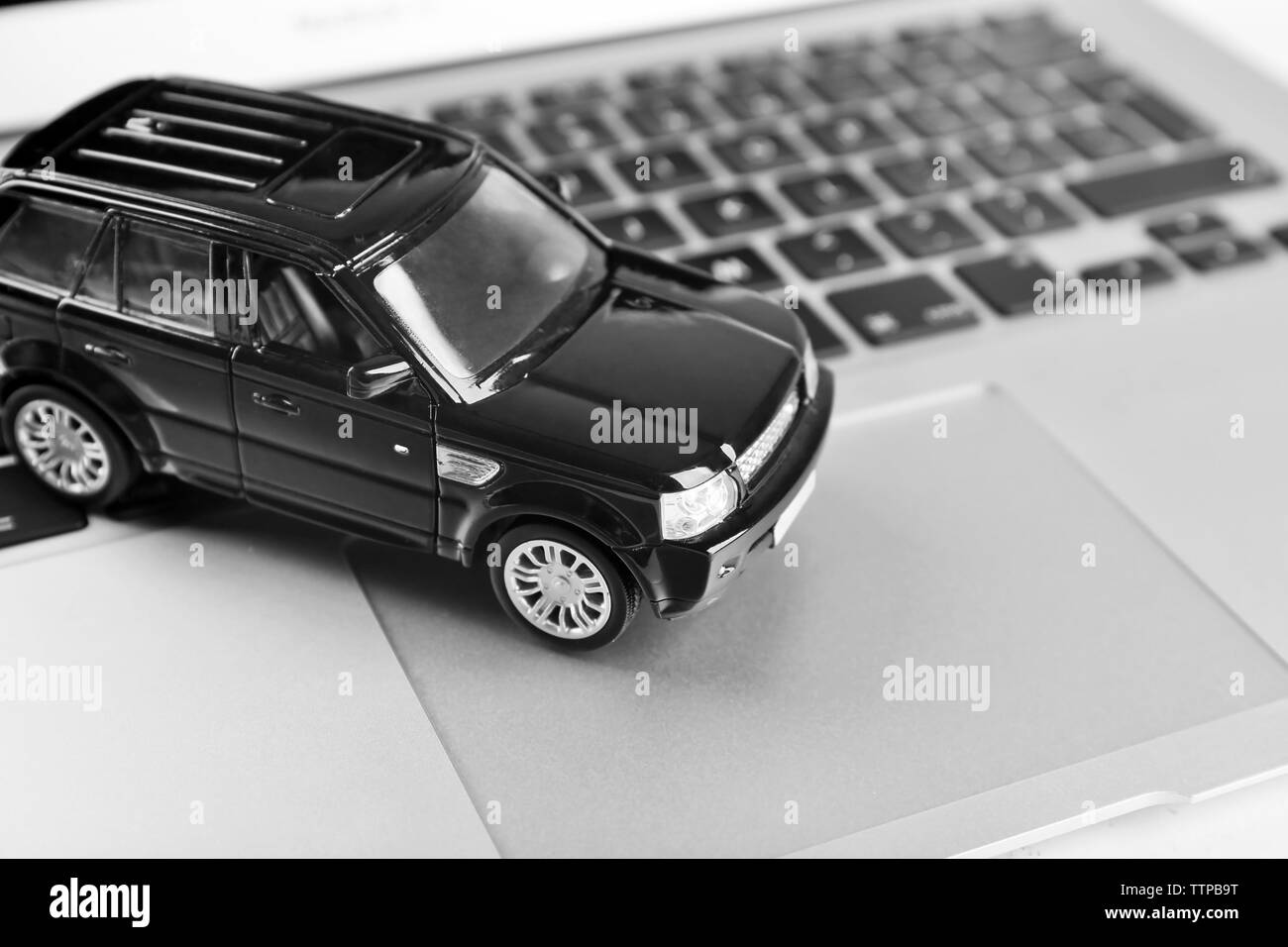 Toy car on laptop keyboard closeup Stock Photo - Alamy