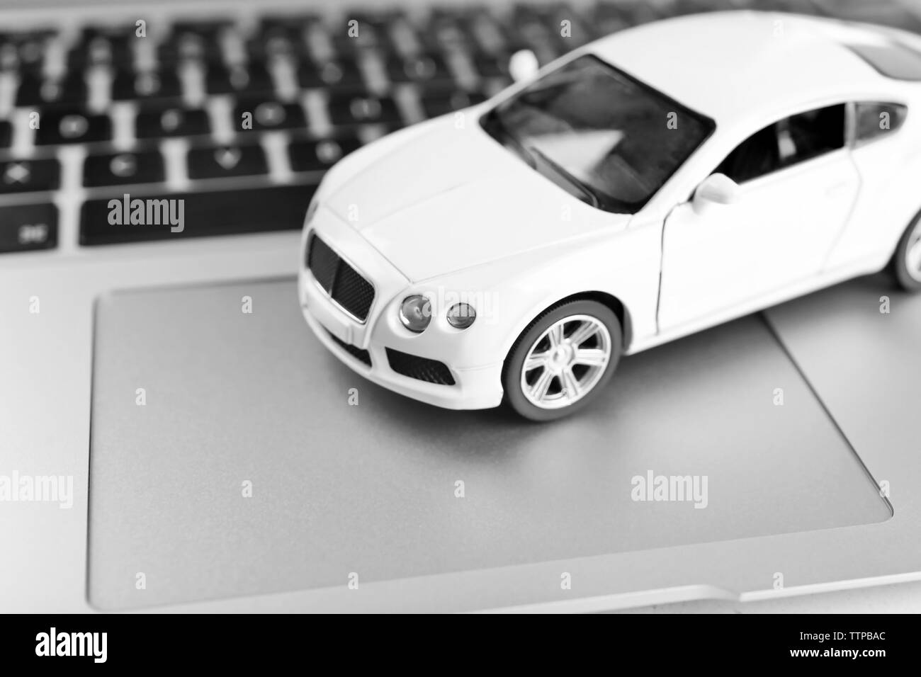 Toy car on laptop keyboard closeup Stock Photo - Alamy