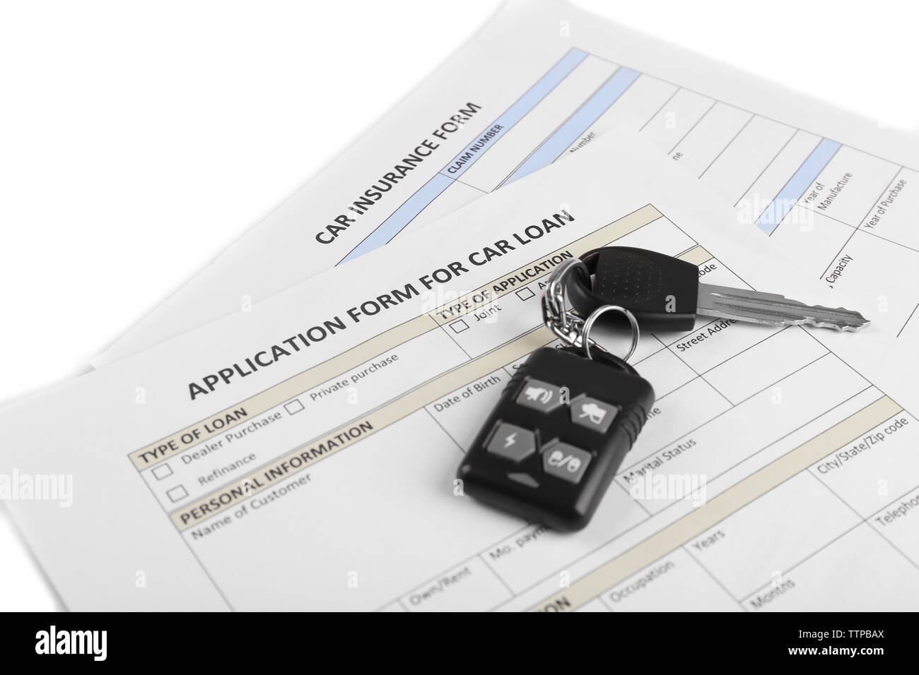 Car key on blank of insurance closeup Stock Photo - Alamy