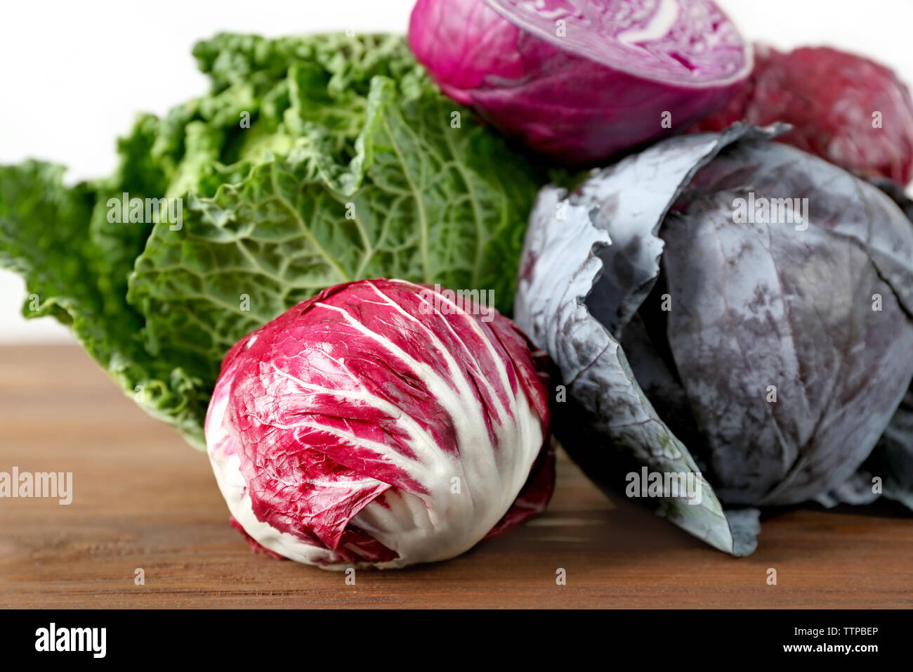 Different kinds of fresh cabbage on brick wall background Stock Photo ...
