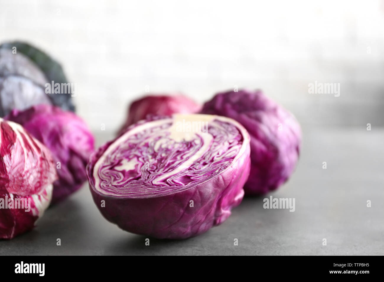 Red cabbage on brick wall background Stock Photo - Alamy