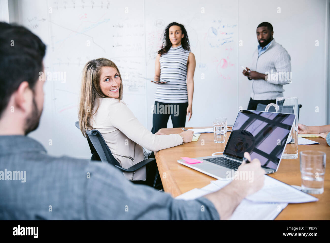 Colleagues looking computer screen in hi-res stock photography and ...