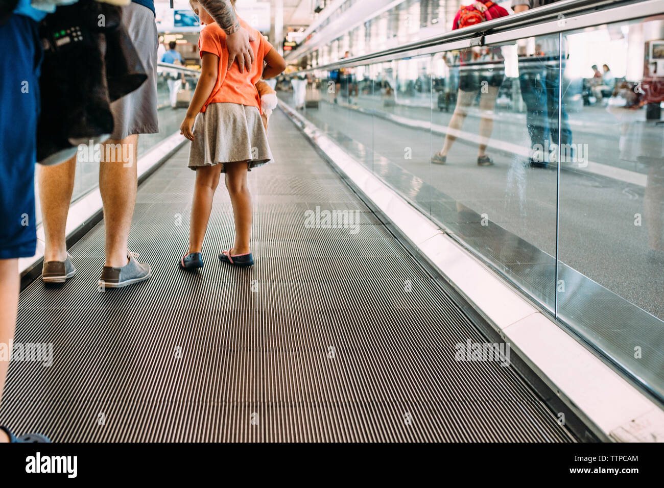 Father and daughter standing on escalator Stock Photo - Alamy