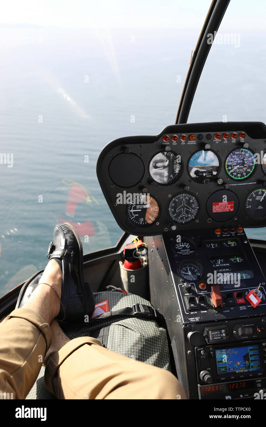 Low section of man relaxing in cockpit of helicopter Stock Photo - Alamy