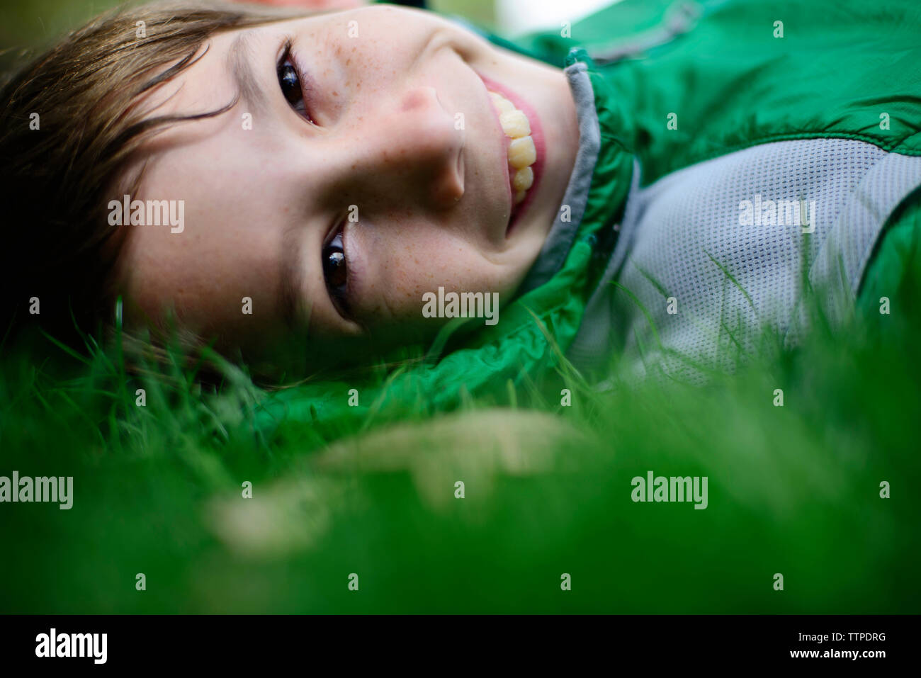 Boy lying down on grass hi-res stock photography and images - Alamy