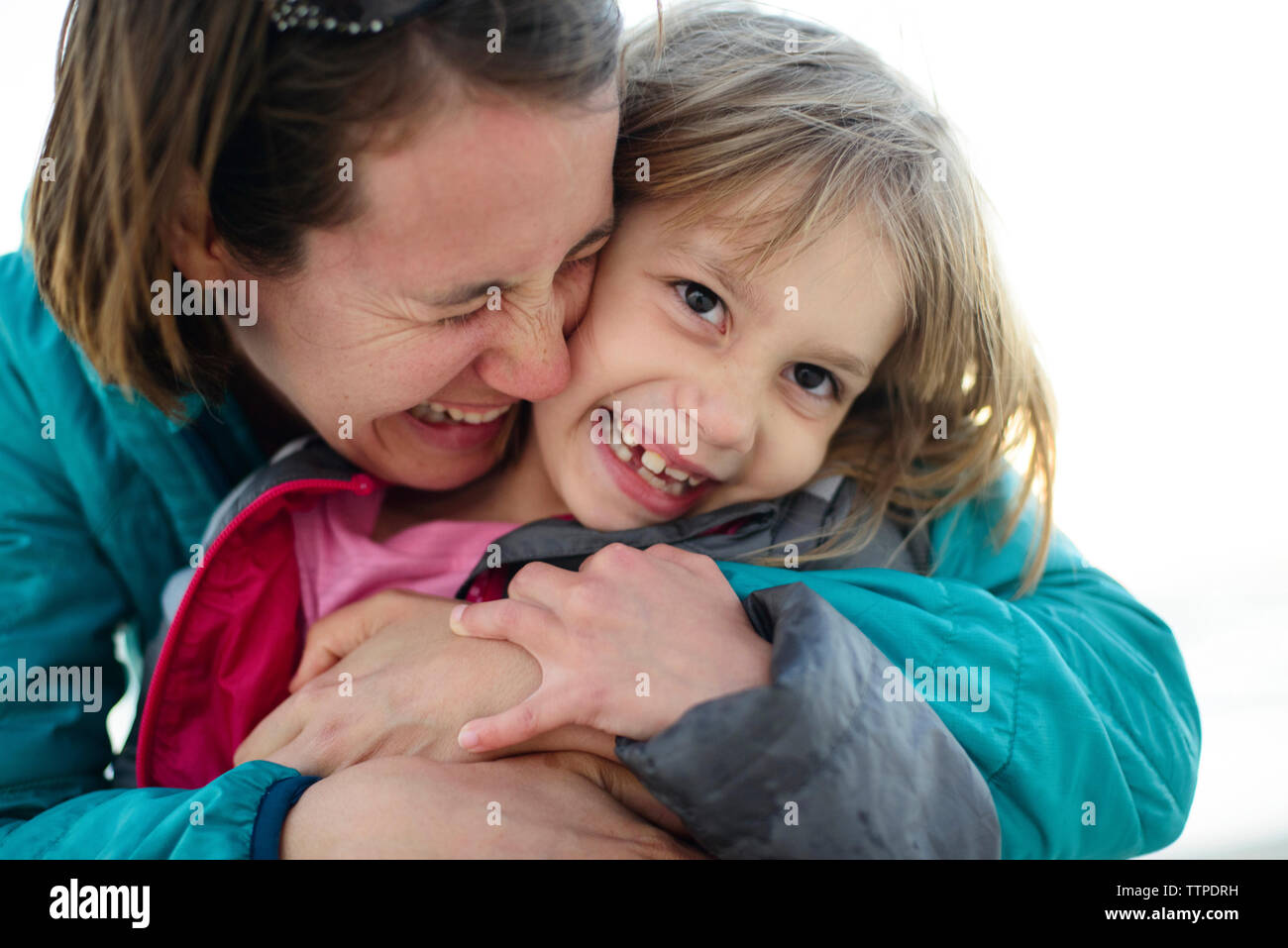 Happy mother embracing daughter Stock Photo - Alamy