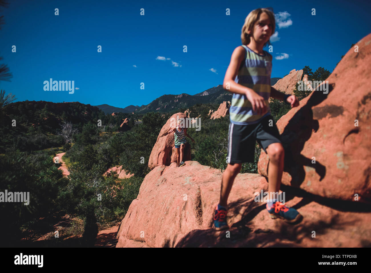 Boy walking on rocks hi-res stock photography and images - Alamy