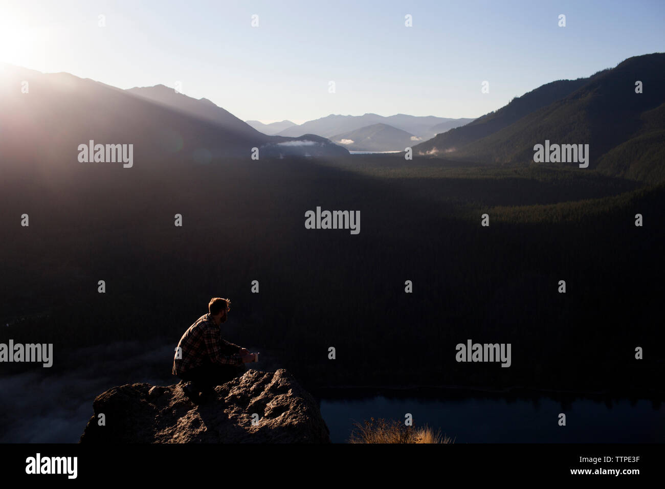 Rear view crouching on rock hi-res stock photography and images - Alamy