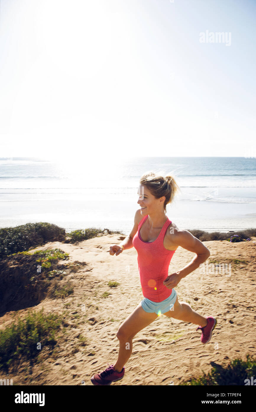Fitness woman running on beach hi-res stock photography and images - Alamy