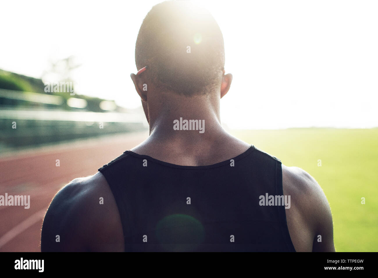 Rear view of male athlete on field Stock Photo - Alamy