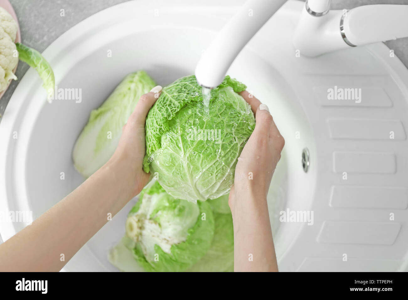 Female hands wash cabbage Stock Photo - Alamy