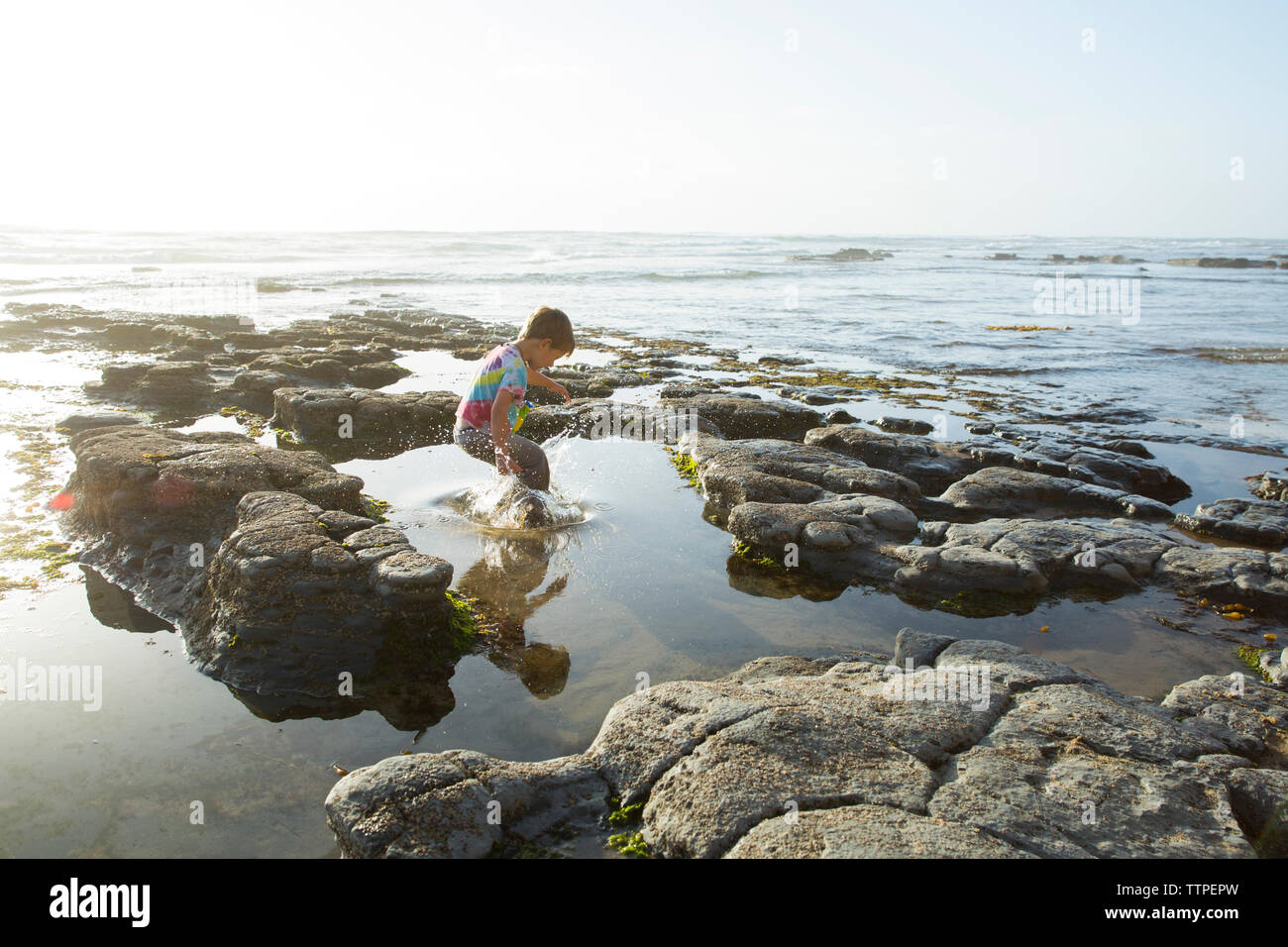 Boy jumping into the sea hi-res stock photography and images - Alamy