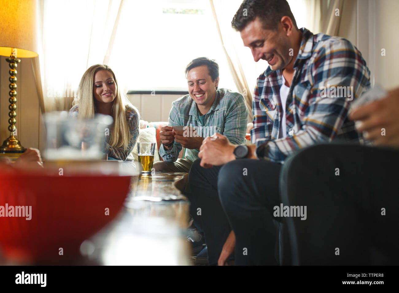Four friends playing game cards hi-res stock photography and images - Alamy