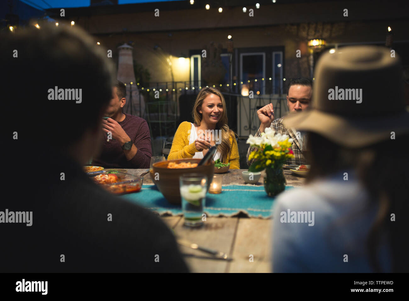 Friends enjoying dinner party at patio Stock Photo - Alamy