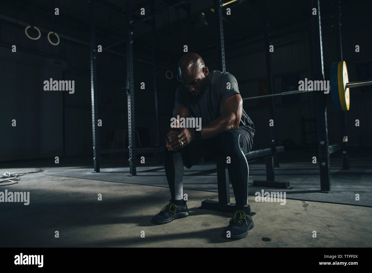 Male athlete relaxing in gym Stock Photo - Alamy