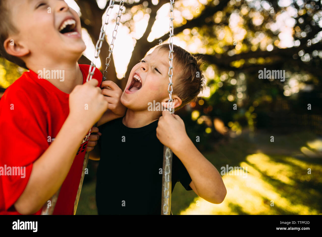 Two boys holding chains hi-res stock photography and images - Alamy
