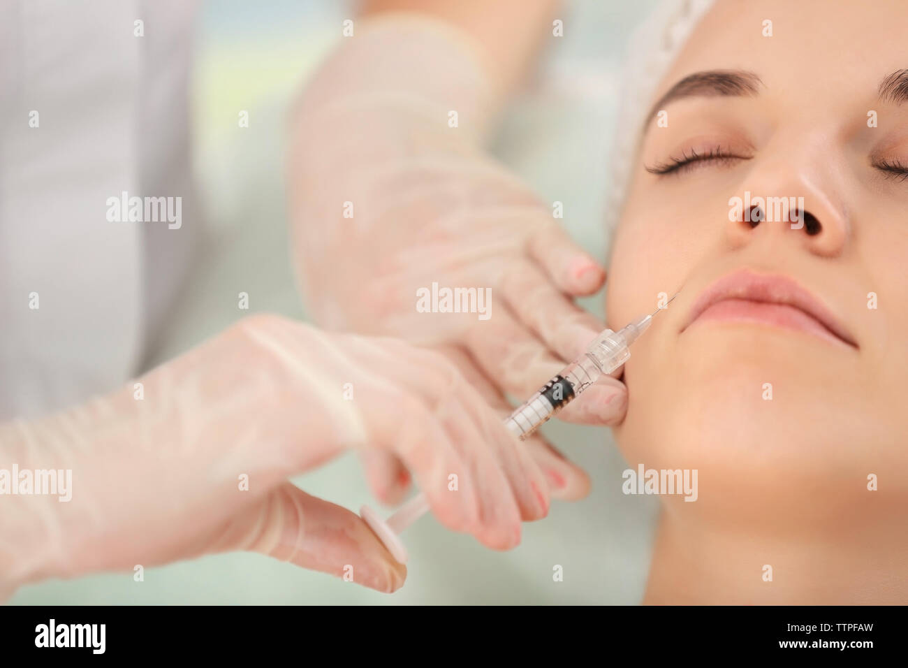 Beautiful woman getting an injection in her face Stock Photo - Alamy