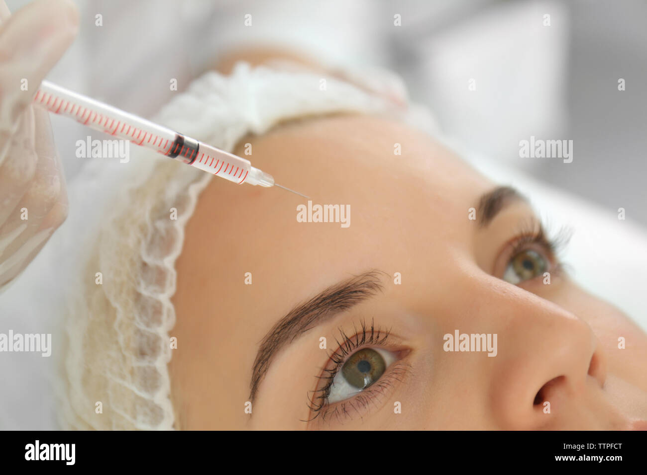 Beautiful woman getting an injection in her face Stock Photo - Alamy