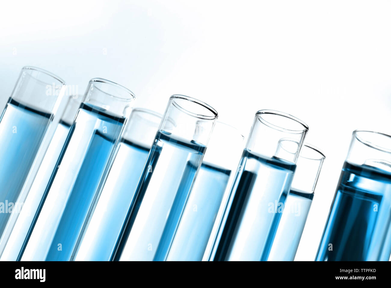 Test tubes with blue samples, close up Stock Photo - Alamy
