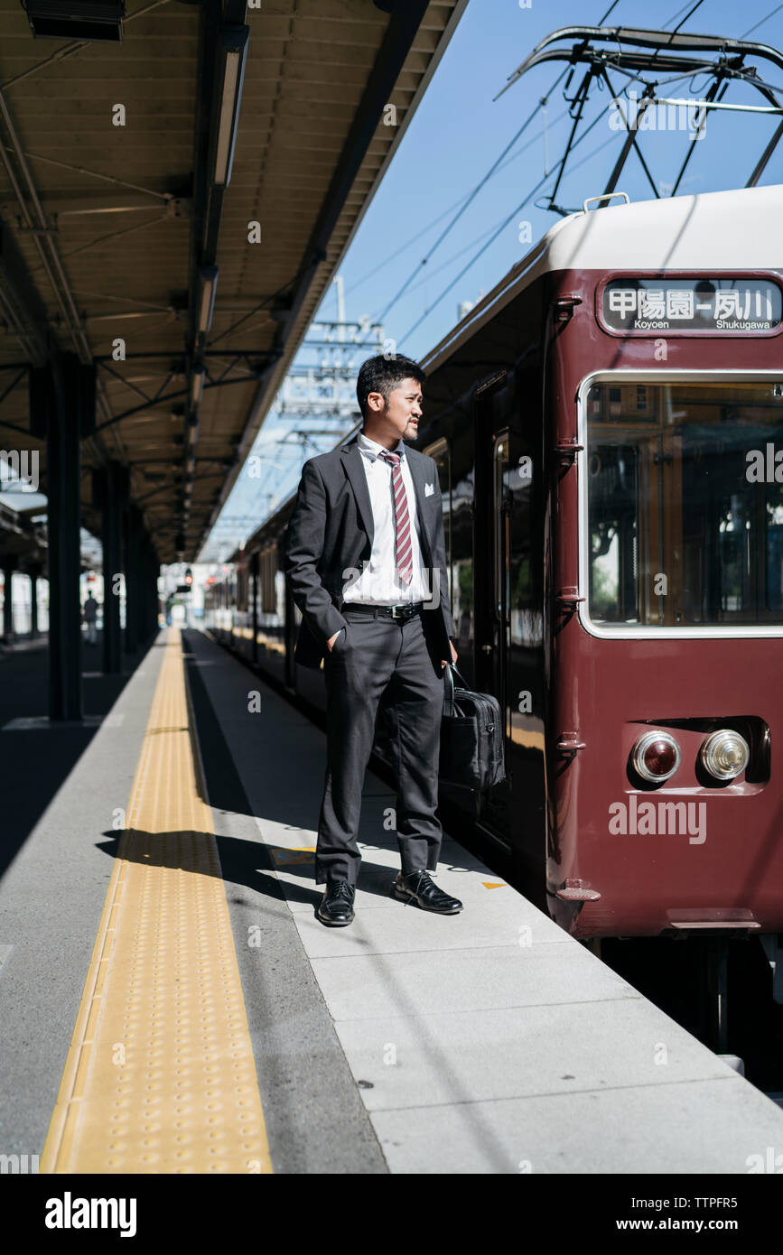 Man standing train station hi-res stock photography and images - Alamy