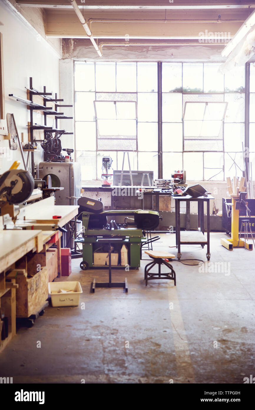 Sunlight falling on tools in empty workshop Stock Photo - Alamy