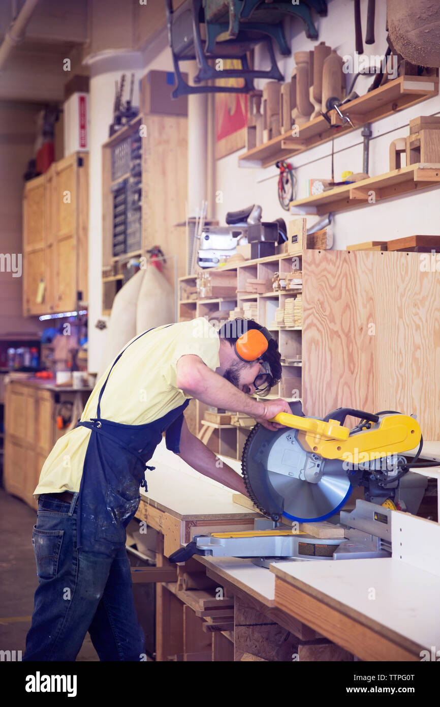 Manual worker using circular saw at wood shop Stock Photo - Alamy