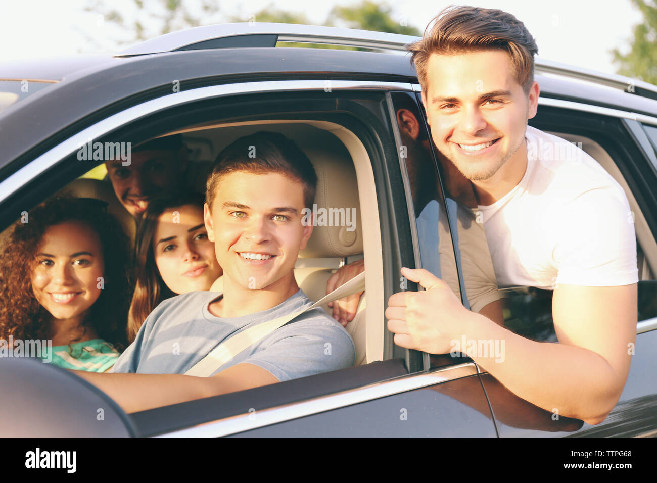 Friends in a car Stock Photo - Alamy