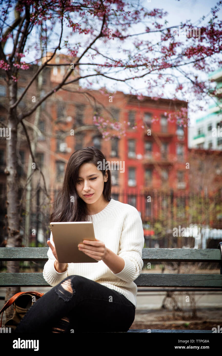 Young woman using tablet computer in city Stock Photo - Alamy
