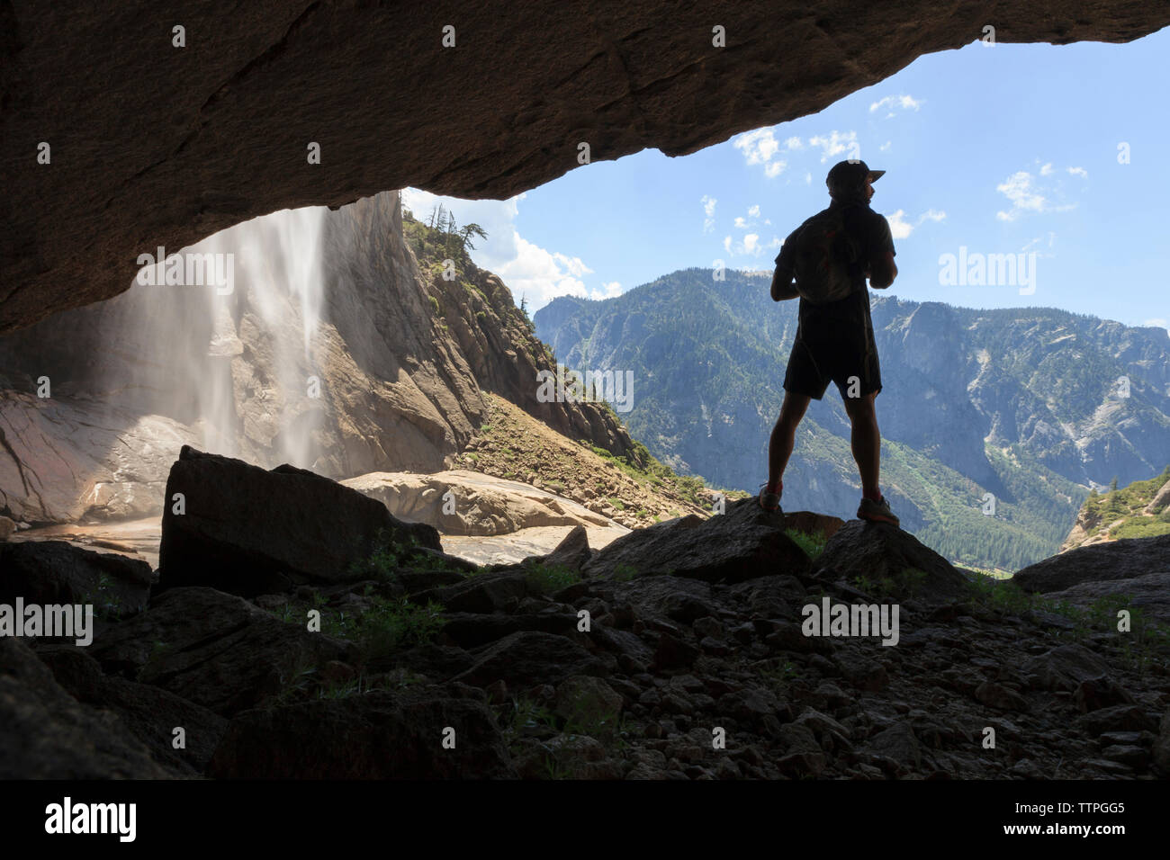 Man standing on rock formation Stock Photo - Alamy