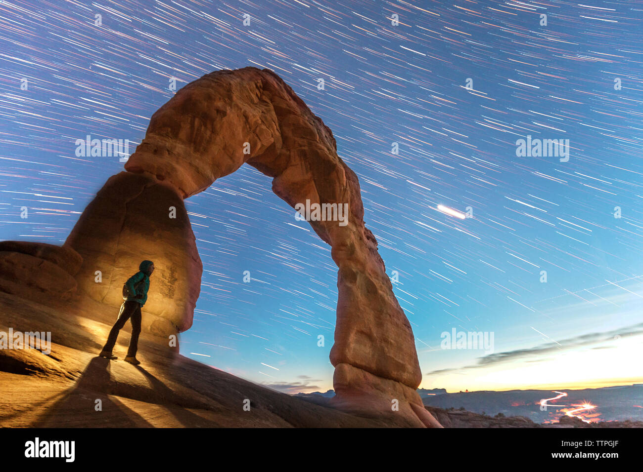 Woman standing rock arch hi-res stock photography and images - Alamy