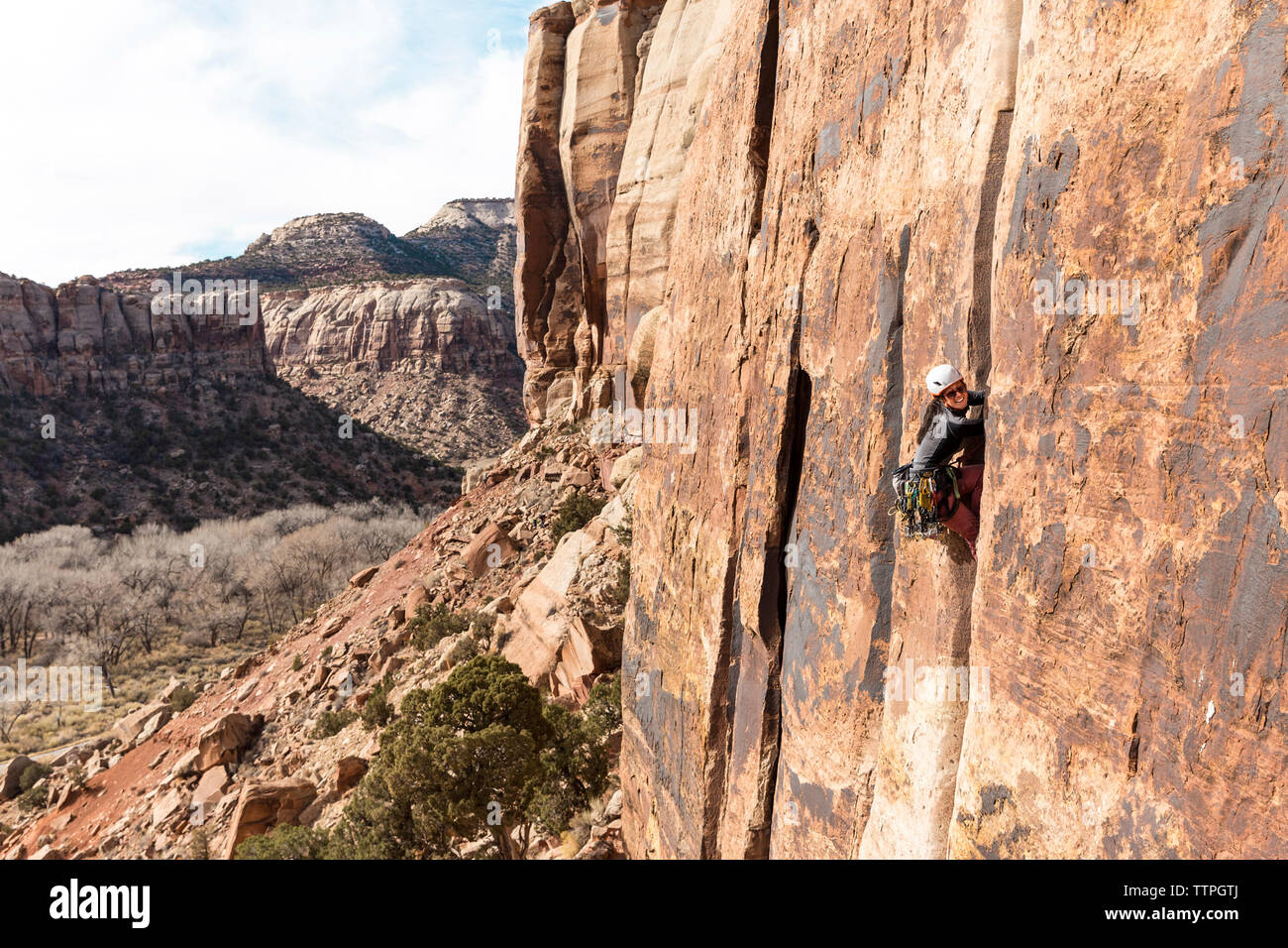 Side view of female hiker climbing mountain Stock Photo - Alamy