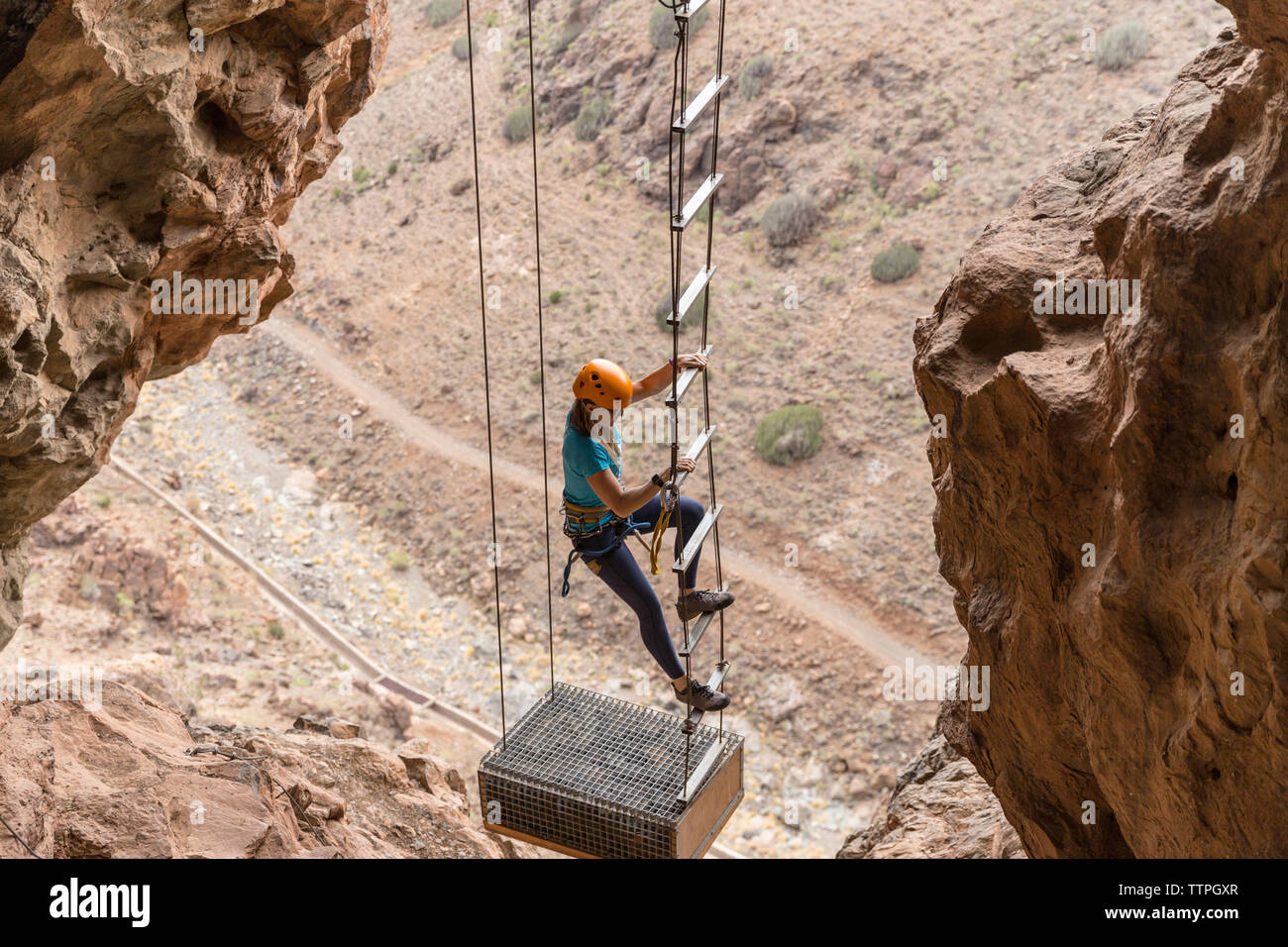 Old woman climbing ladder hi-res stock photography and images - Alamy